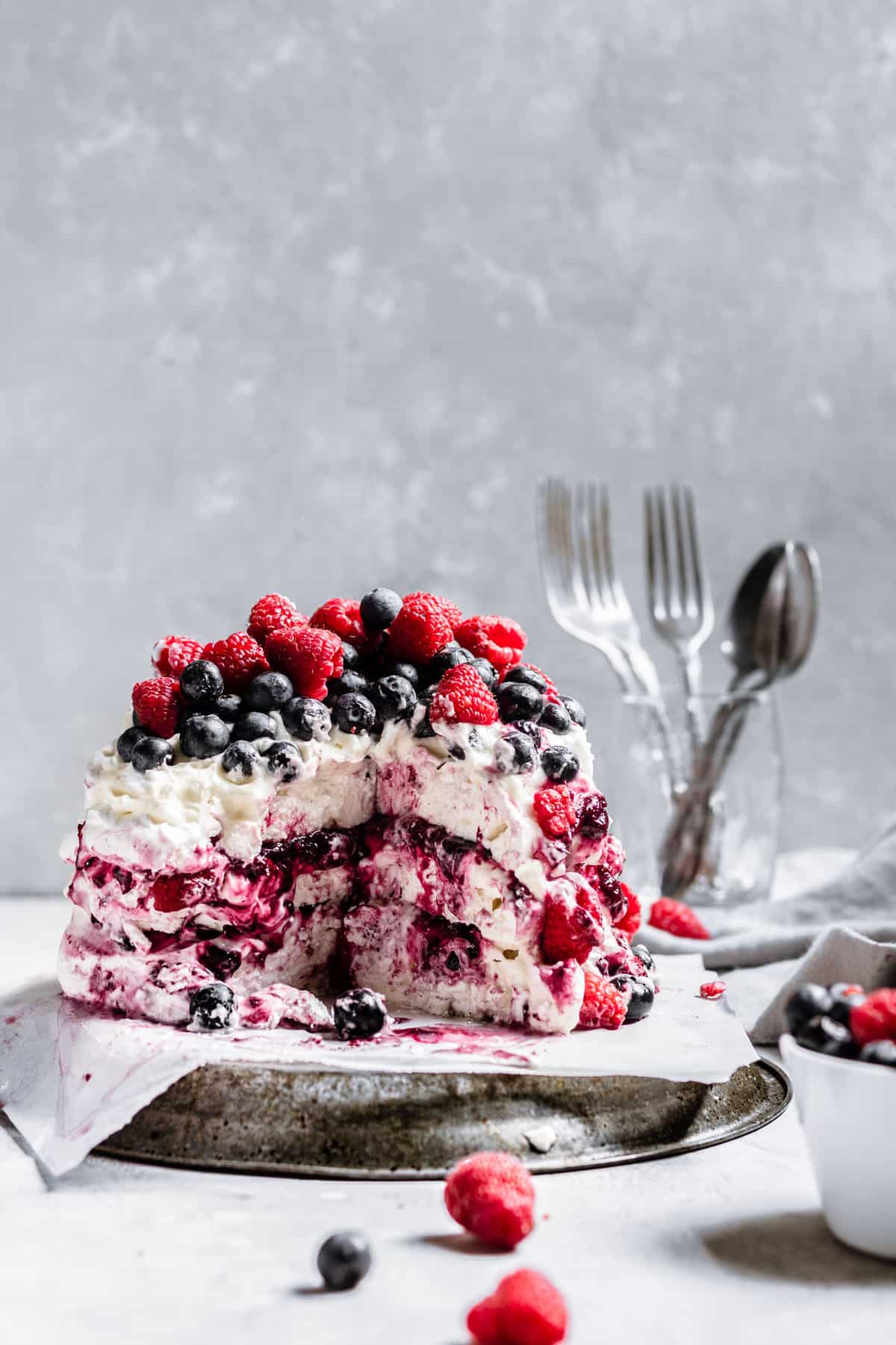 Berry Pavlova Cake is a sweet and creamy dessert.